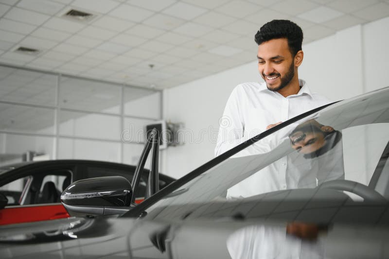Happy Indian Man Checking Car Features at Showroom Stock Photo - Image ...