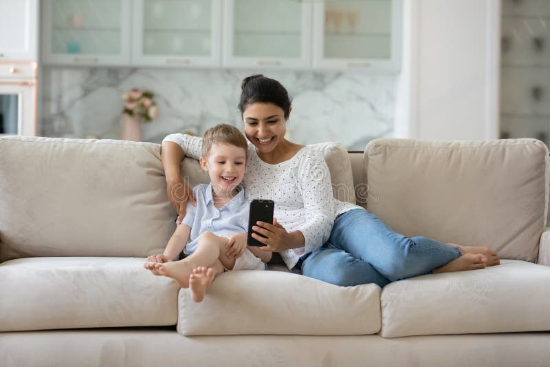 Happy Indian Mother and Caucasian 7s Son Using Smartphone Together ...