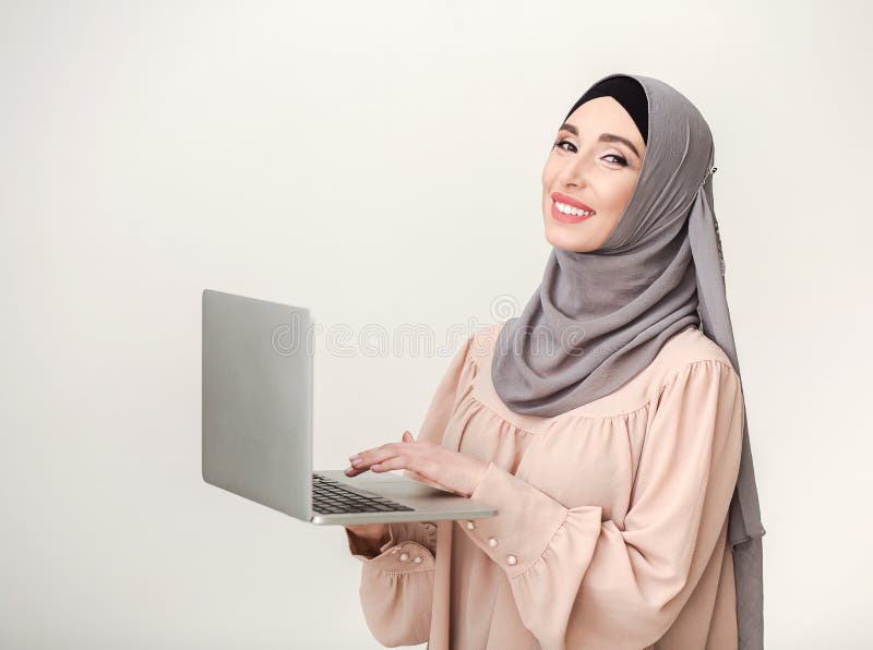 Saudi Woman Using Laptop at Studio Background Stock Photo - Image of ...