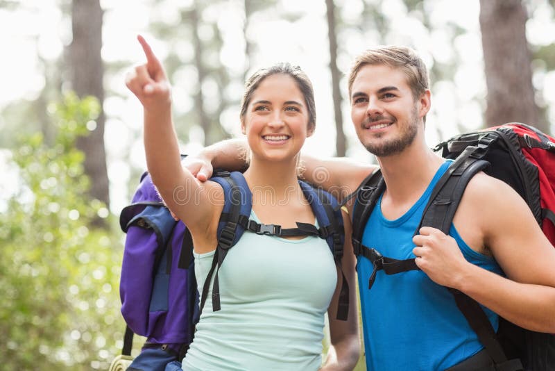 Happy Joggers Looking Away while Pointing Stock Photo - Image of adult ...