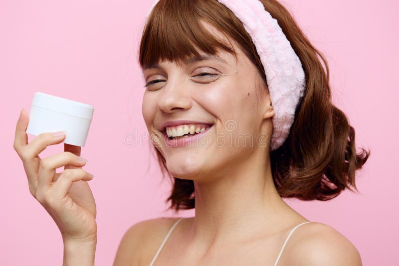 A Happy, Joyful, Young Woman Stands Squinting Her Eyes from a Smile and ... A Happy, Joyful, Young Woman Stands Squinting Her Eyes from a Smile and ...