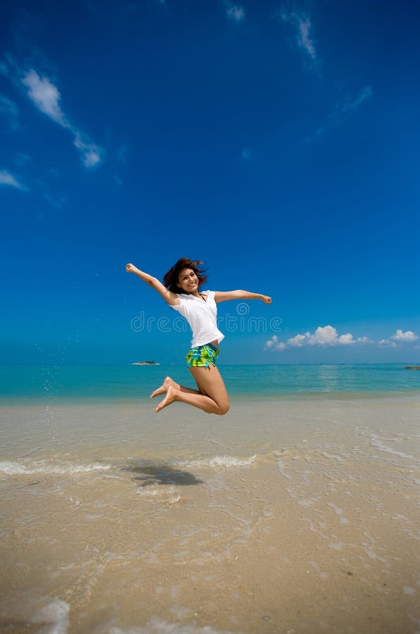 Happy jump at the beach stock image. Image of girls, blue - 3695825