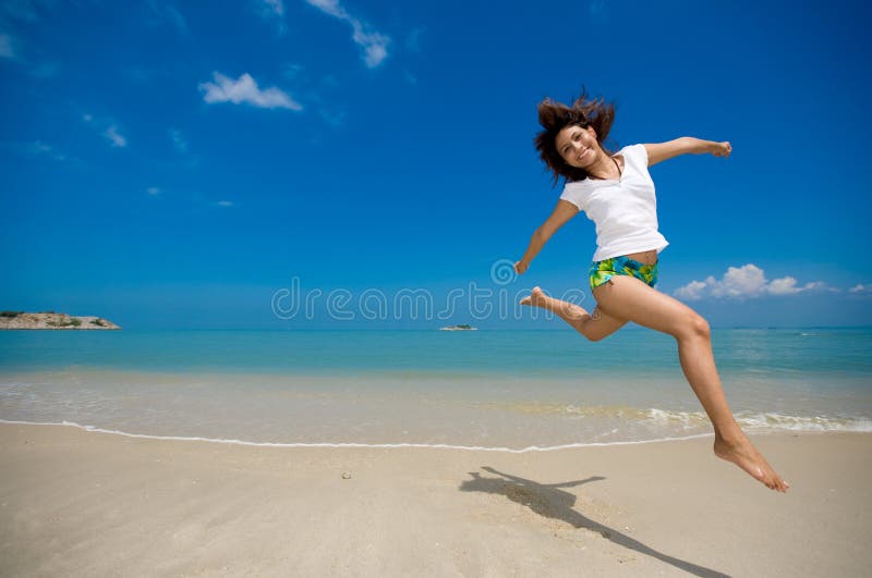 Happy jump at the beach stock image. Image of girls, blue - 3695825