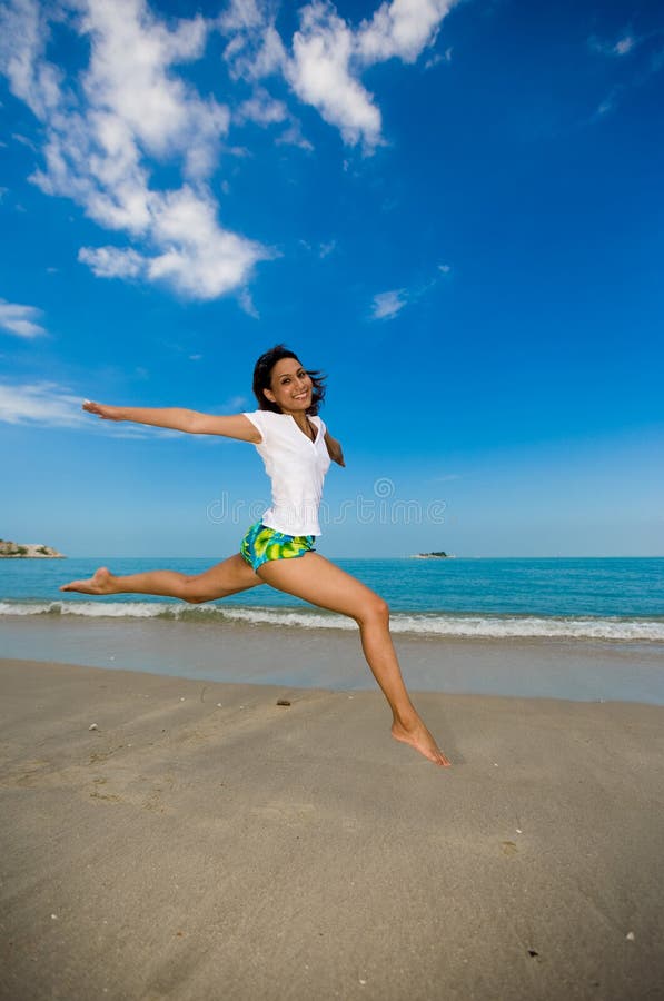 Happy jump at the beach stock image. Image of expression - 3695935