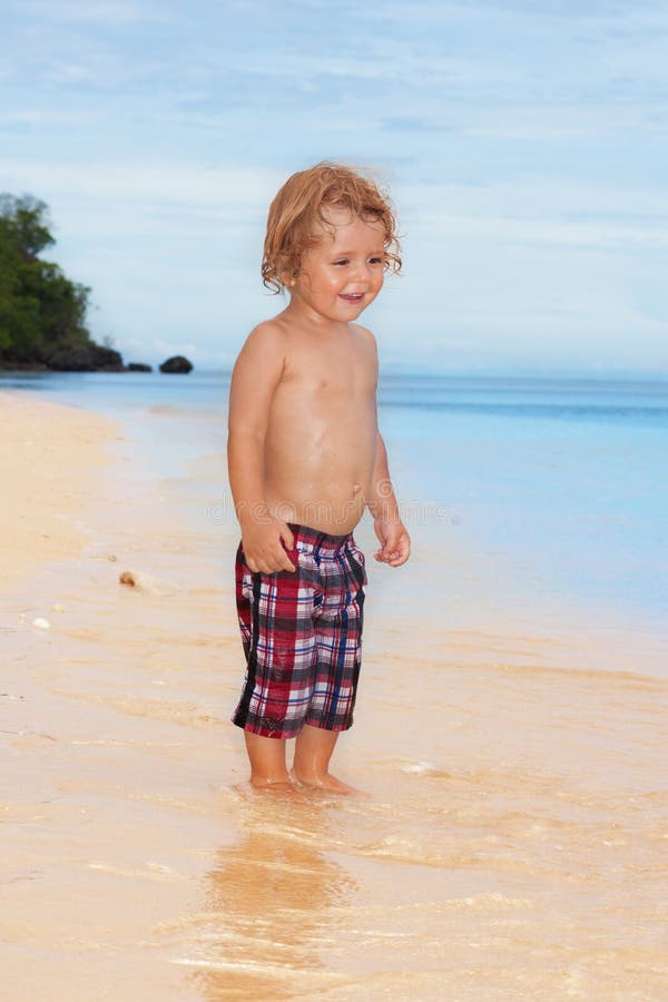 Happy kid on the beach stock photo. Image of baby, child - 25227690