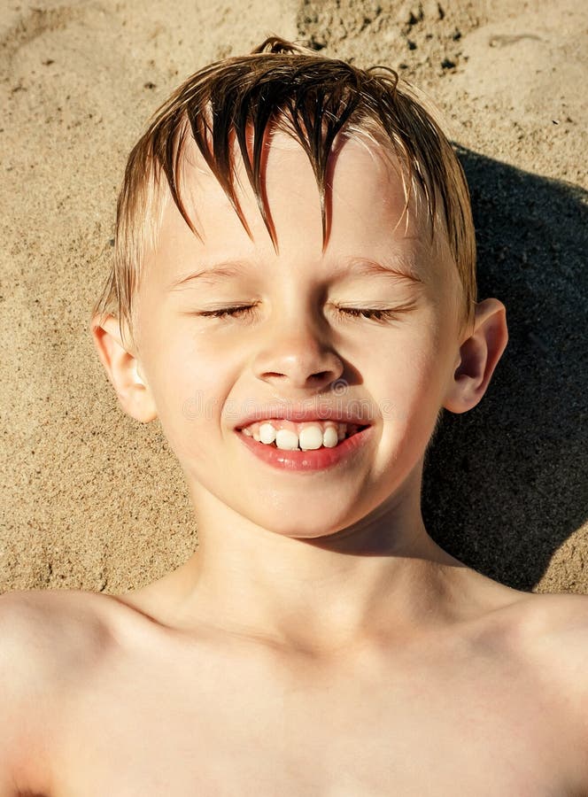 Happy kid at the beach stock image. Image of closeup - 324023519