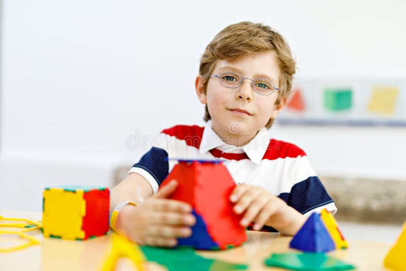 Happy Kid Boy with Glasses Having Fun with Building and Creating ...