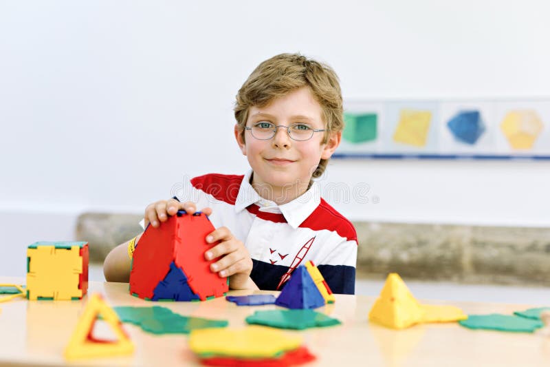 Happy Kid Boy with Glasses Having Fun with Building and Creating ...