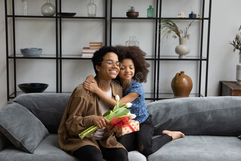Happy Kid Embracing Grateful Young Mom Holding Present Box Stock Photo ...