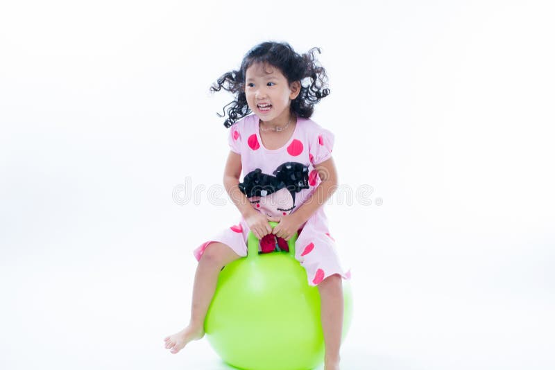 Happy Kid Girl Jumping on Bouncing Ball Stock Photo - Image of ...