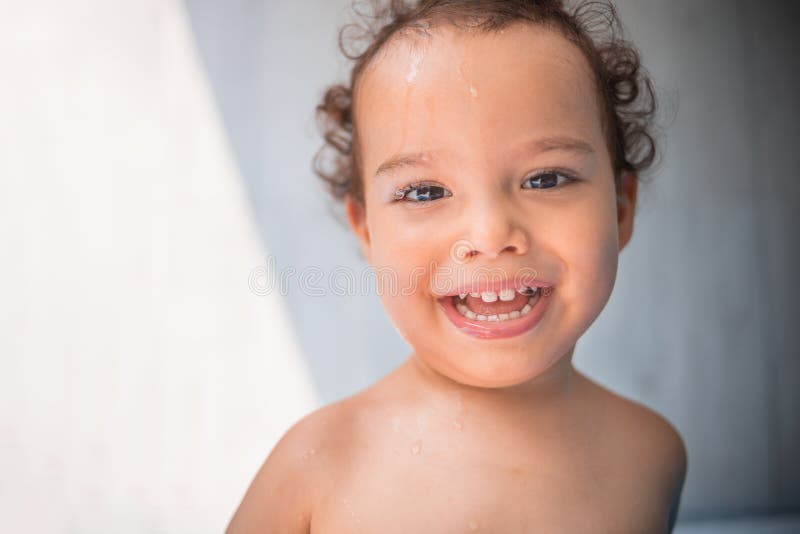 Happy Kid Playing in an Inflatable Pool in the Backyard. Curly Toddler ...