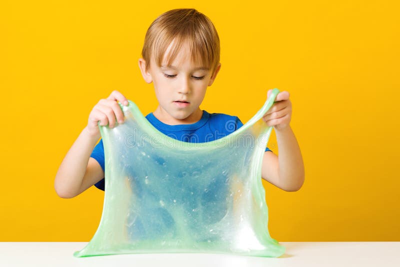 Happy Kid Plays with Handmade Toy Slime. Cute Boy Doing Experiment ...