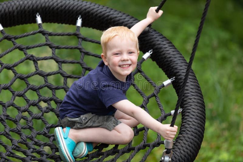 Happy Kid sat on a swing stock photo. Image of energy - 124685776