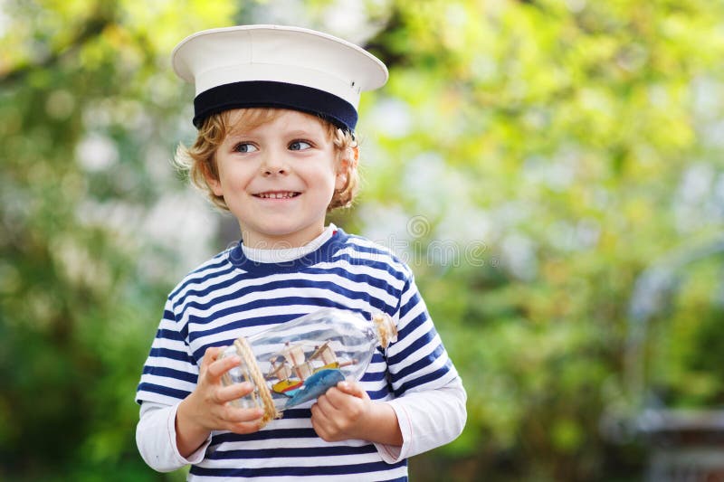Happy Kid in Skipper Uniform Playing with Toy Ship Stock Image - Image ...