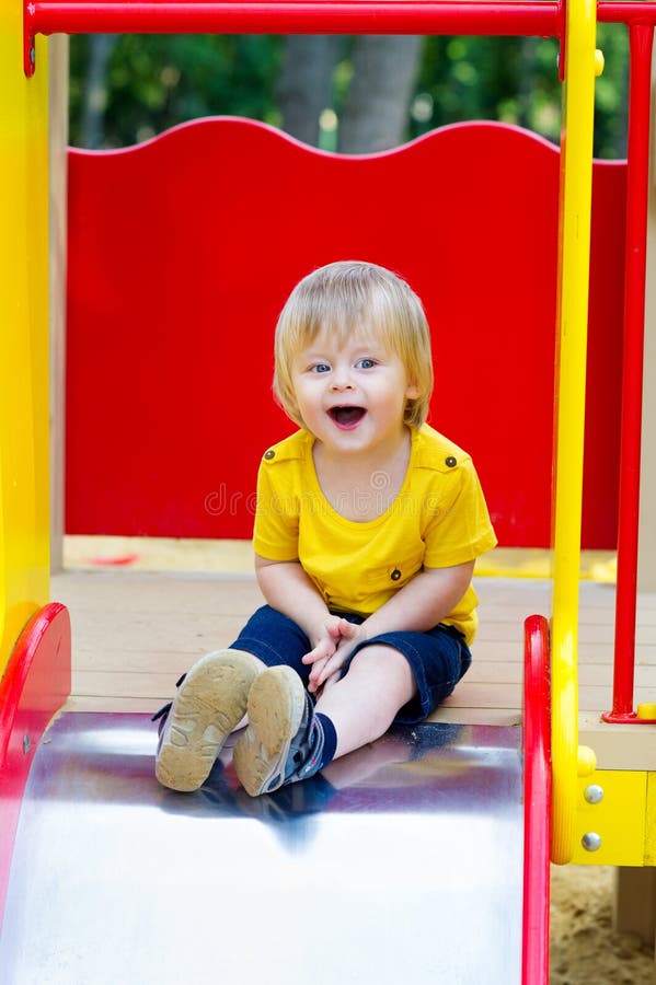 Happy kid on the slide stock image. Image of outside - 31309509