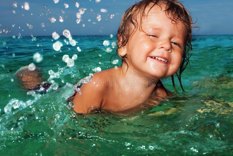 Happy Kid Splashing in the Sea Stock Image - Image of sport, outdoor ...