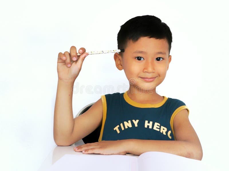 Happy Kid while Studying Getting an Idea Holding a Pencil and Sitting ...