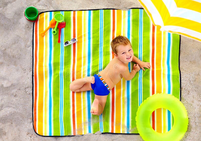 Happy Kid Sunbathing on Colorful Beach Stock Photo - Image of ...