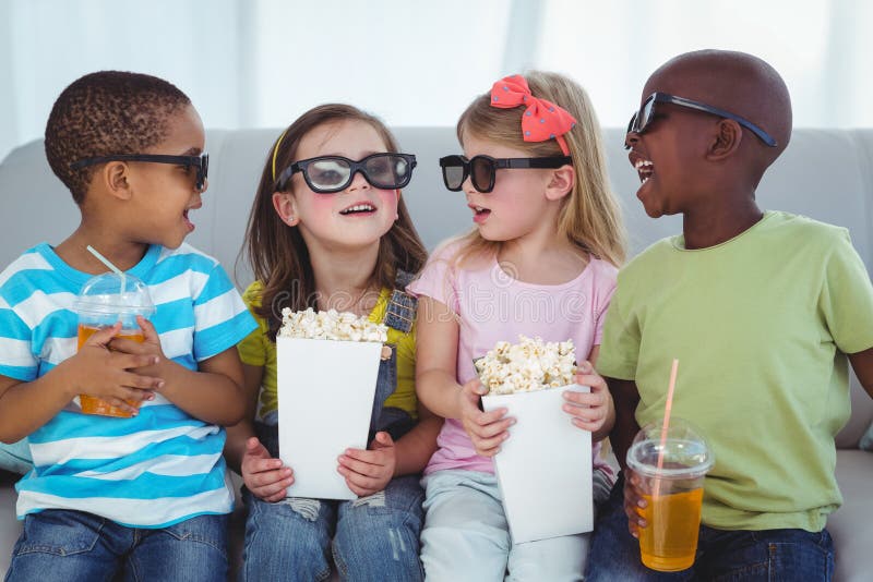 Happy Kids Enjoying Popcorn and Drinks while Sitting Stock Photo ...