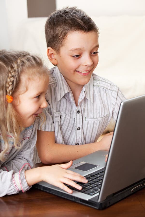 Happy kids with laptop stock image. Image of brother - 65208317