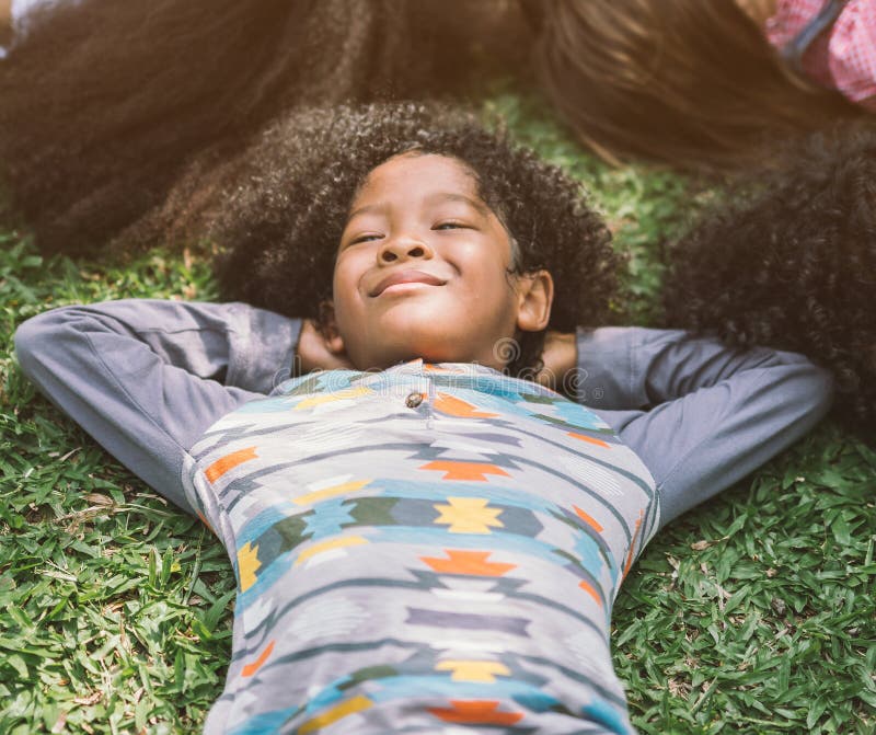 Happy Kids Laying on Grass in Park Stock Photo - Image of garden, boys ...