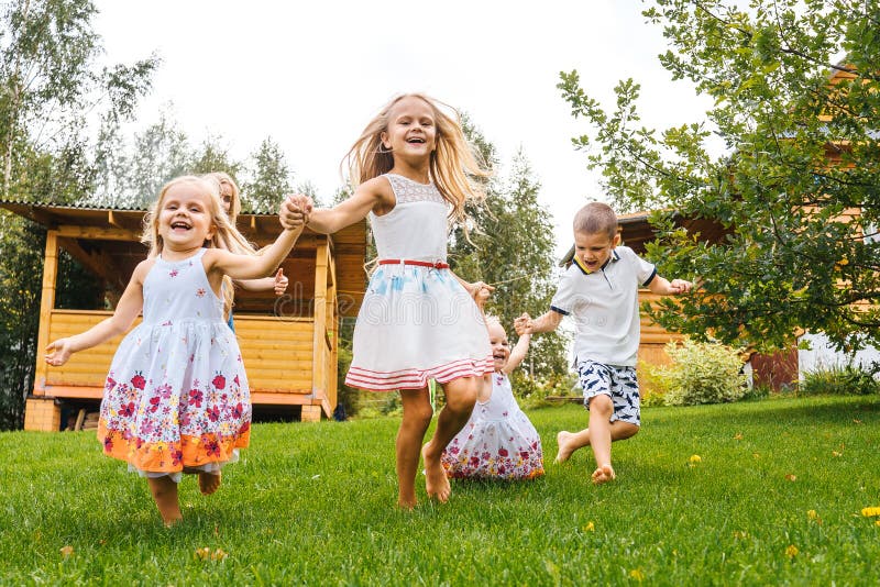 Happy Kids Running in Garden on Grass Stock Photo - Image of activity ...