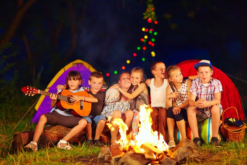 Happy Kids Singing Songs Around Camp Fire Stock Photo - Image: 43815001