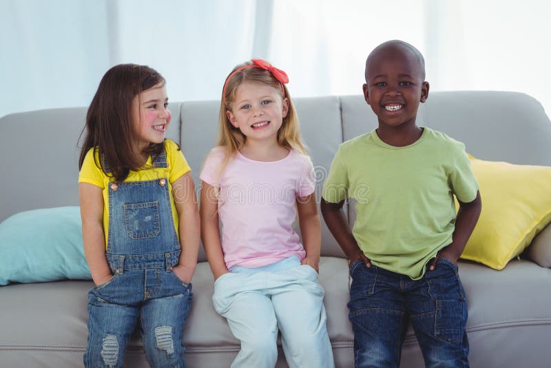 Happy Kids Sitting Together Stock Photo - Image of pillows, male: 61438450