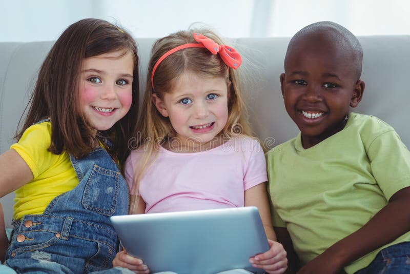 Happy Kids Sitting Together with a Tablet Stock Image - Image of ...