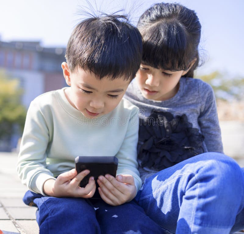 Happy Kids Watching the Mobile Phone at School Stock Image - Image of ...