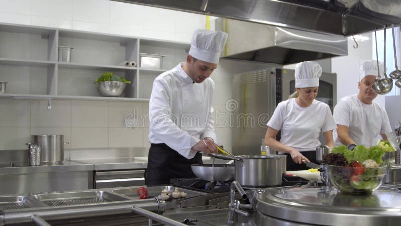 Happy Kitchen Crew with Chef Singing and Dancing while Cooking Stock ...
