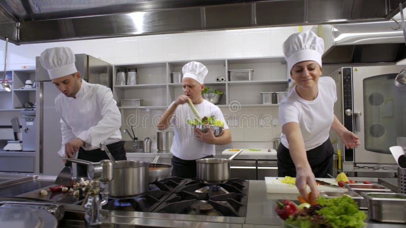 Happy Kitchen Crew with Chef Singing and Dancing while Cooking Stock ...