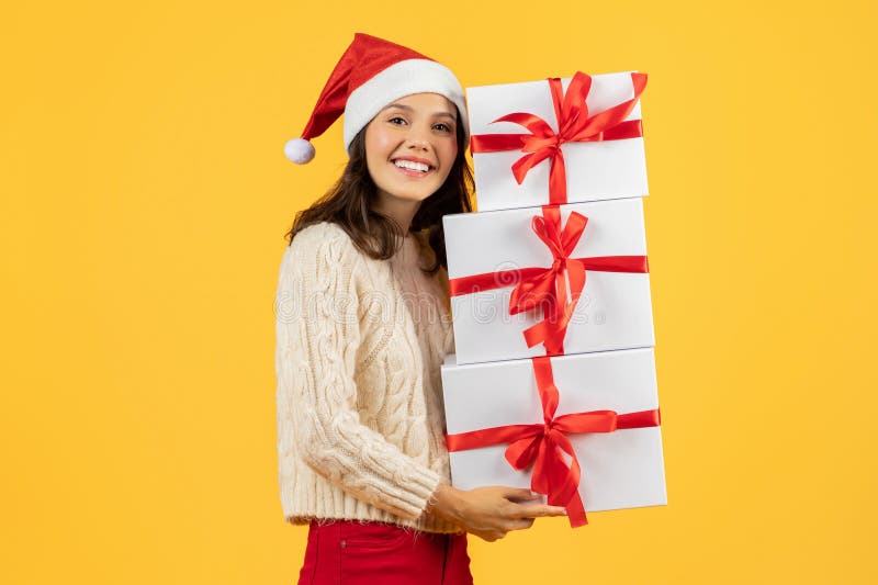 Happy Lady Holding Multiple Xmas Boxes Stack on Yellow Backdrop Stock ...