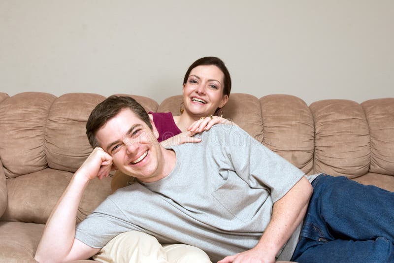 Happy, Laughing Couple Sitting On Couch - Horizo Picture. Image: 5433617