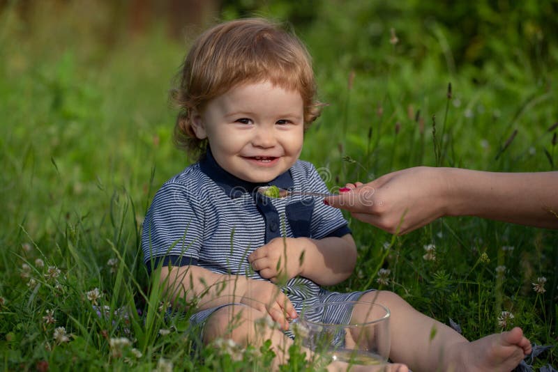Happy Little Baby is Being Fed Using Spoon. Spoon Feeding Baby. Stock ...