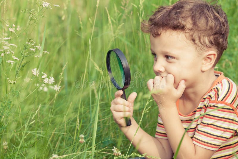 Happy Little Boy Exploring Nature with Magnifying Glass Stock Photo ...