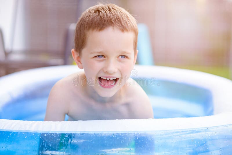 Happy Little Boy in Garden Pool Stock Photo - Image of playful, splash ...