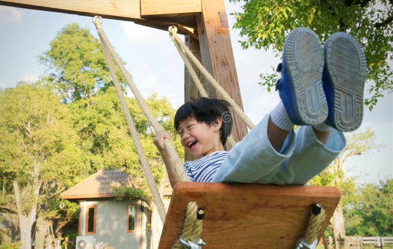 Happy Little Boy Laughing and Swinging on a Swing Stock Image - Image ...