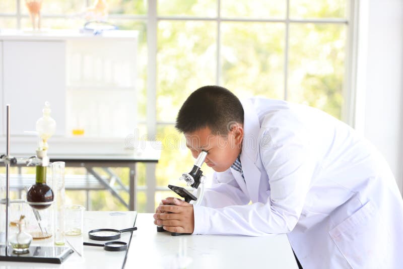 Happy Little Boy Making Science Experiments with Microscope Education ...