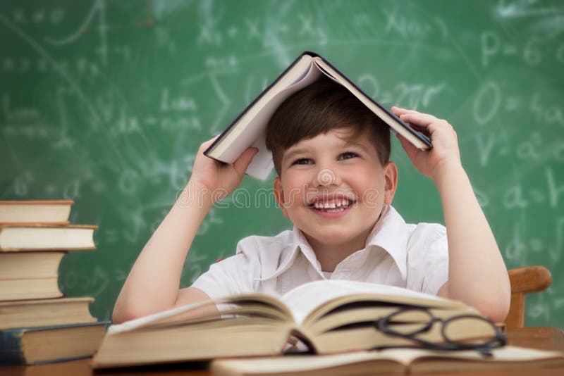 Happy Little Boy, Pupil with Book on Head Stock Image - Image of ...