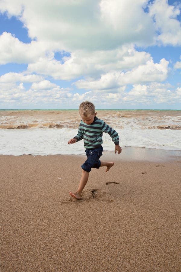 Happy Little Boy Running at the Sea Coast Stock Photo - Image of ...
