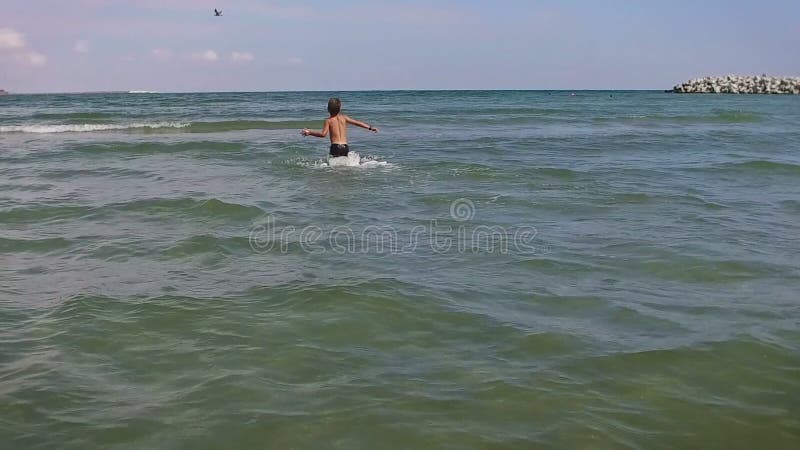 Happy Little Boy Running into Water, Slow Motion Stock Video - Video of ...
