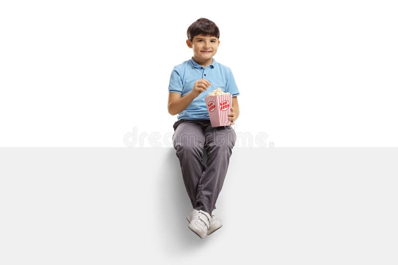 Happy Little Boy Sitting on a Panel and Eating Popcorn Stock Image ...