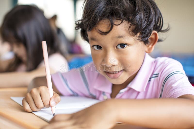 Happy Little Boy Studying in the Classroom Stock Image - Image of ...