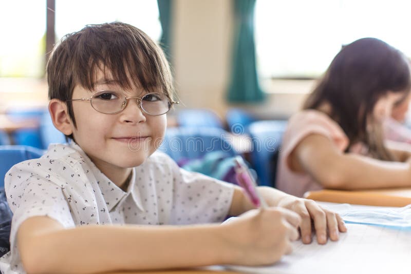 Happy Little Boy Studying in the Classroom Stock Photo - Image of happy ...