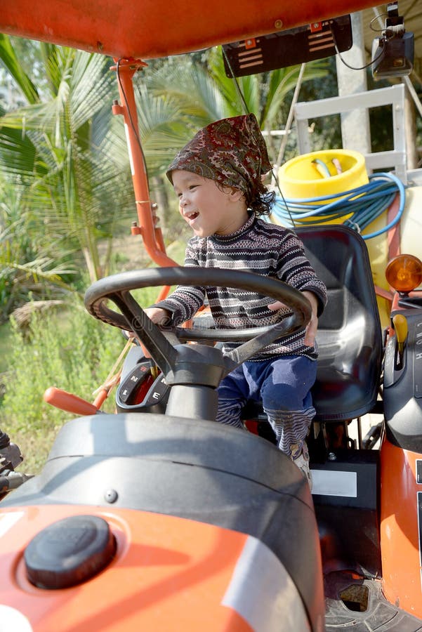 Happy Little Boy of Two Years Having Fun on Tractor in Summer Stock ...