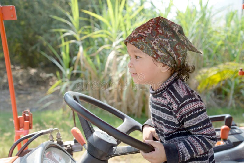 Happy Little Boy of Two Years Having Fun on Tractor in Summer Stock ...