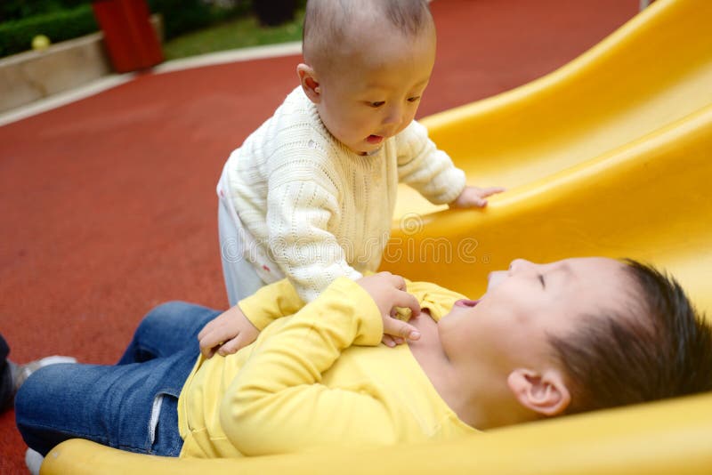 Brothers on the Playground Slide Stock Photo - Image of person, baby ...
