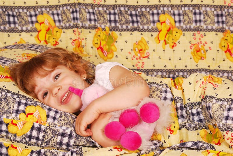 Happy little girl bedtime stock photo. Image of beauty - 14964698