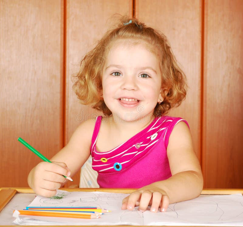 Happy little girl drawing stock photo. Image of cute - 15563542